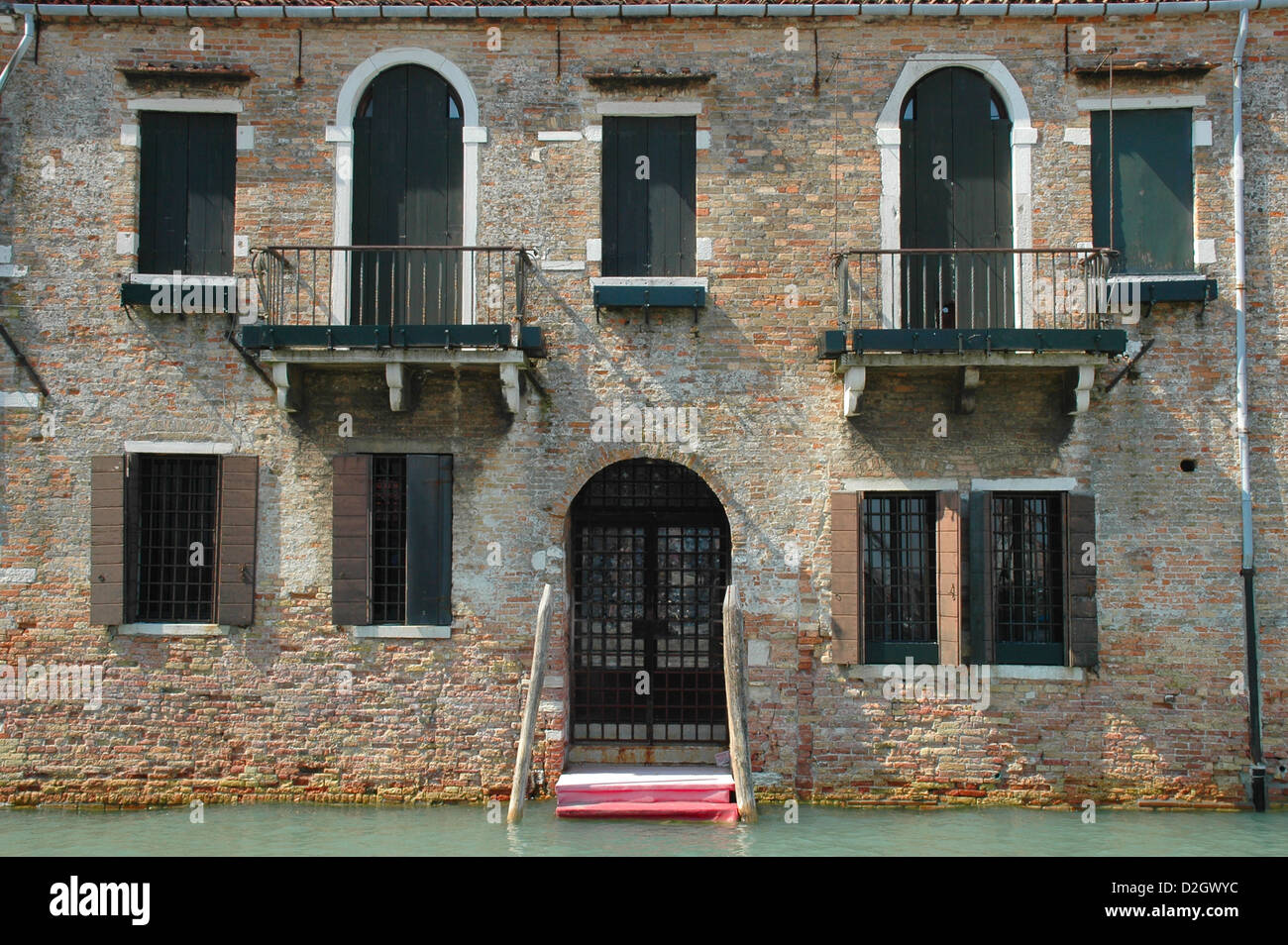 Detail of a building in Venice with shuttered windows, balconies and an ...