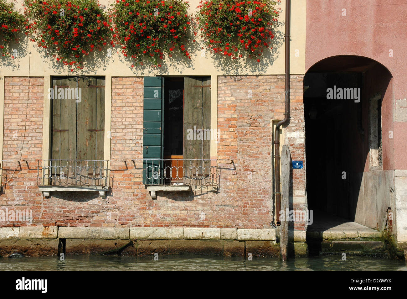 Detail of a building in Venice with shuttered windows and window boxes ...
