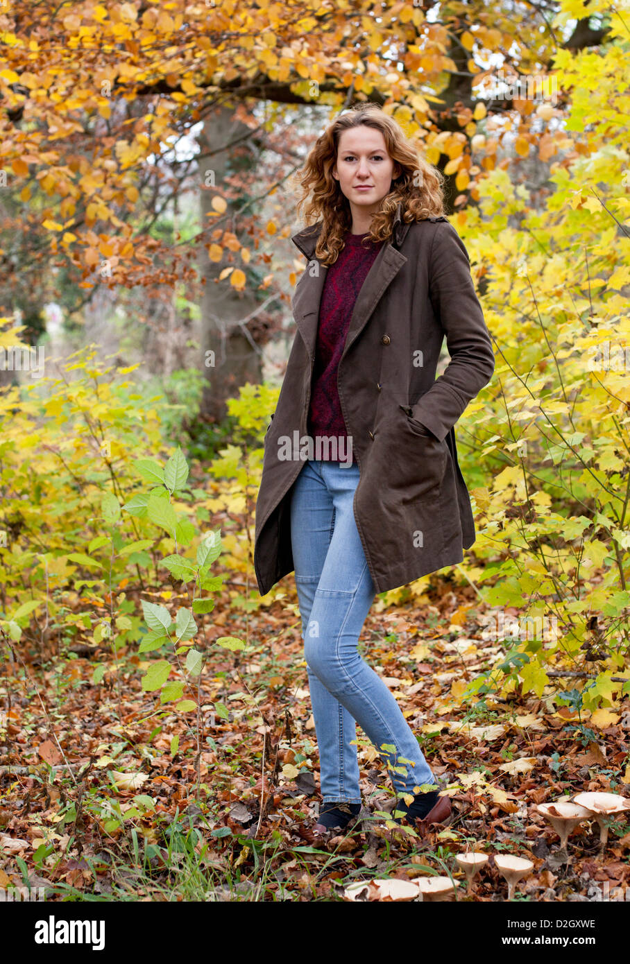 Female student on a campus break in an autumn landscape with toadstools ...