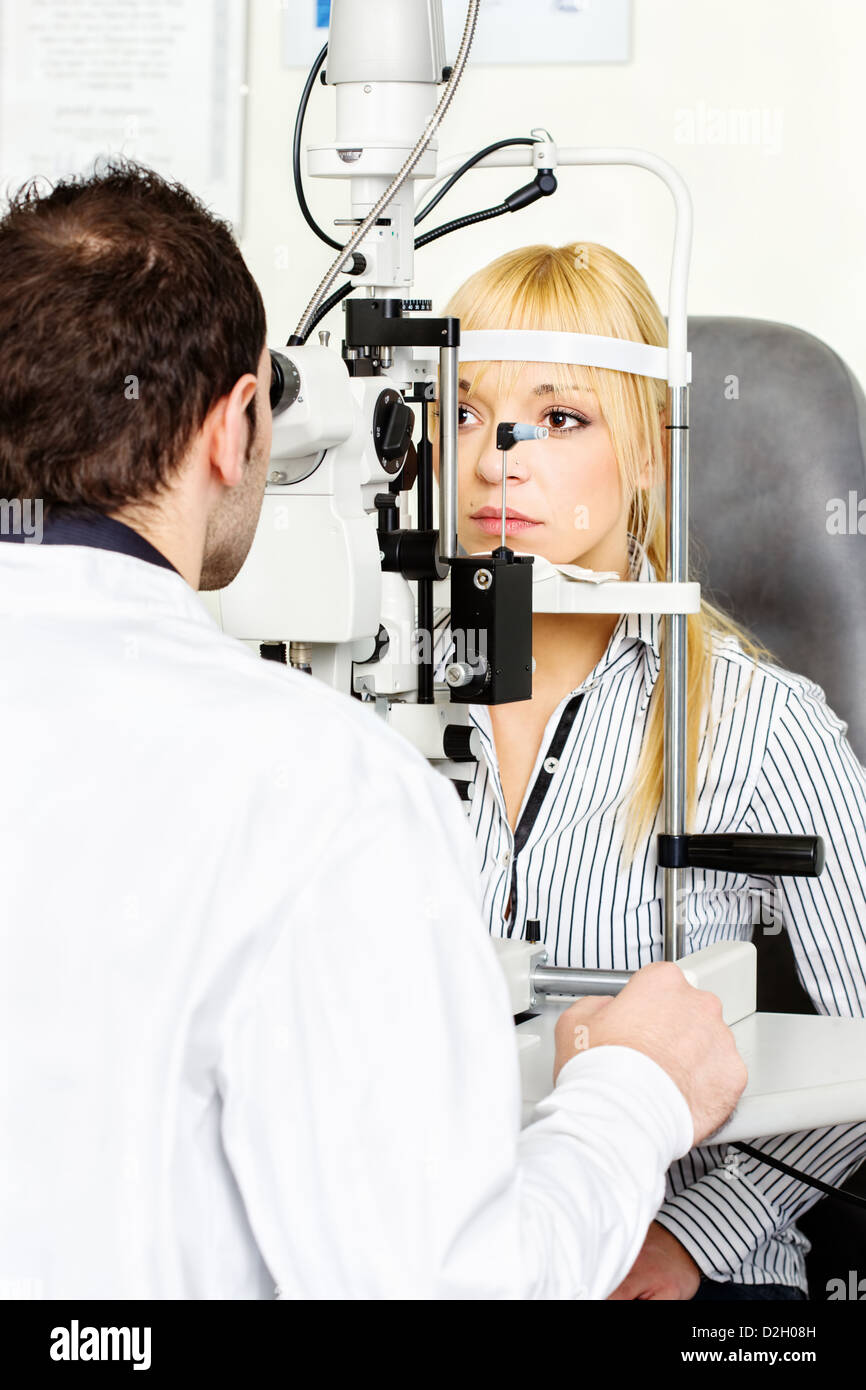 Eye doctor performing an eye examination Stock Photo - Alamy