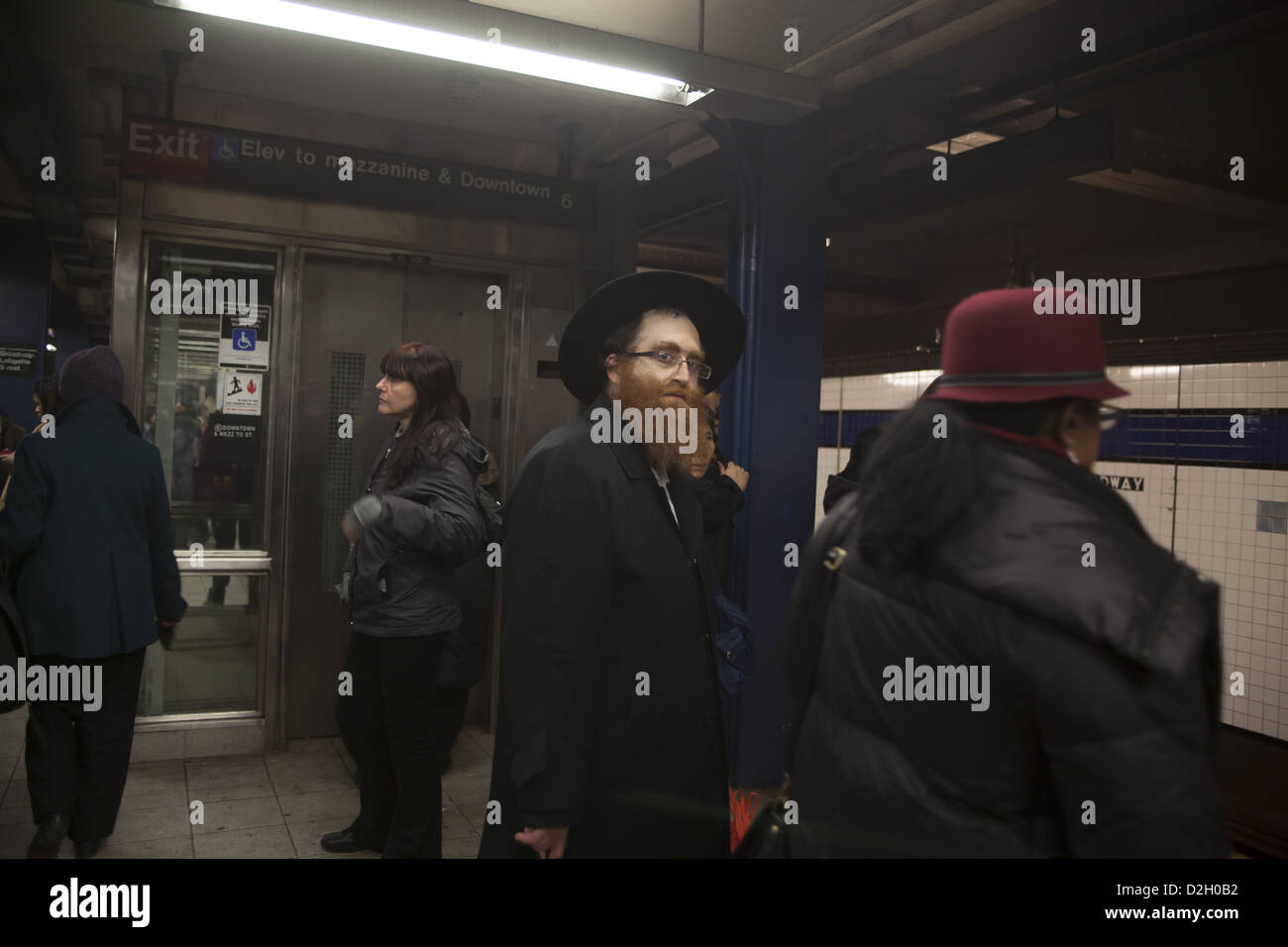People wait for an F train at the Broadway/Lafayette station in ...