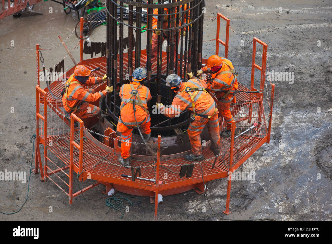 Plunge pile column steel directed into place by workers at the ...
