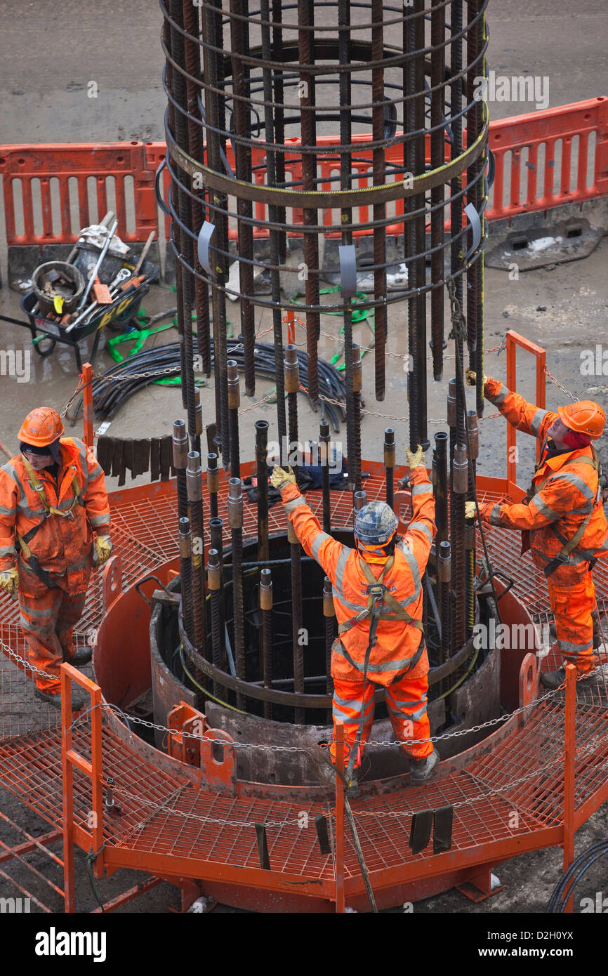 Plunge pile column steel directed into place by workers at the ...