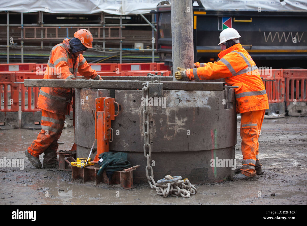 Plunge pile column cement directed into place by workers at the ...