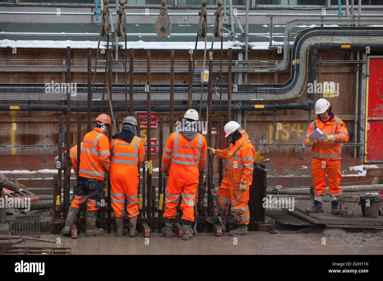 Plunge pile column steel directed into place by workers at the ...
