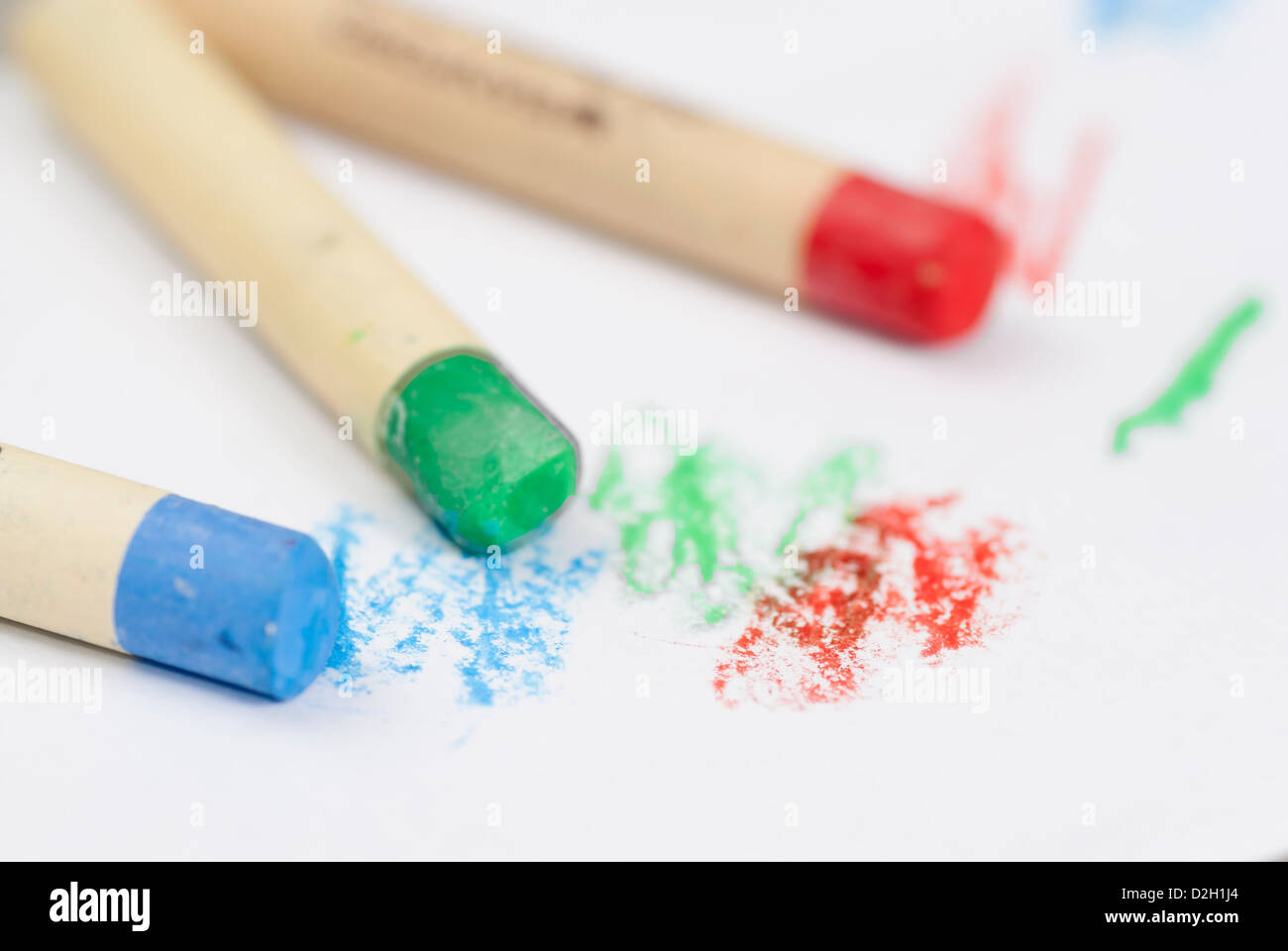 Crayons and paper with elementary drawing Stock Photo - Alamy