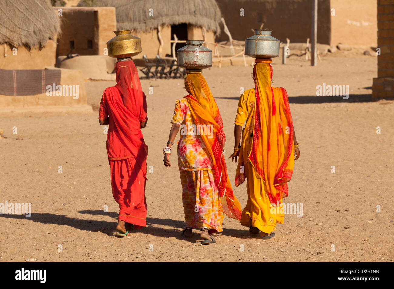 India, Rajasthan, Thar Desert, Three Indian women carrying water back ...