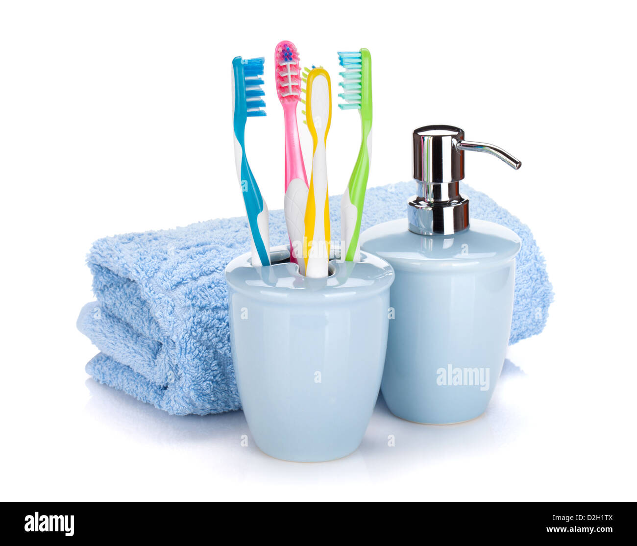 Four colorful toothbrushes, liquid soap and towel. Isolated on white ...