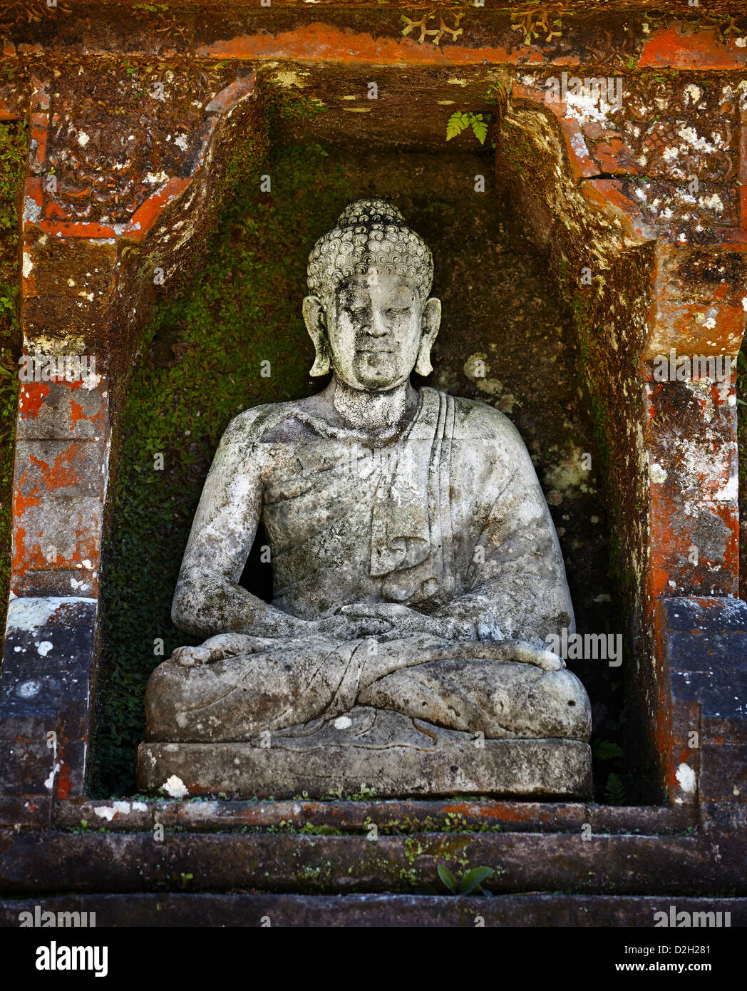 Old stone traditional asian Buddha statue in niche Bali, Indonesia ...