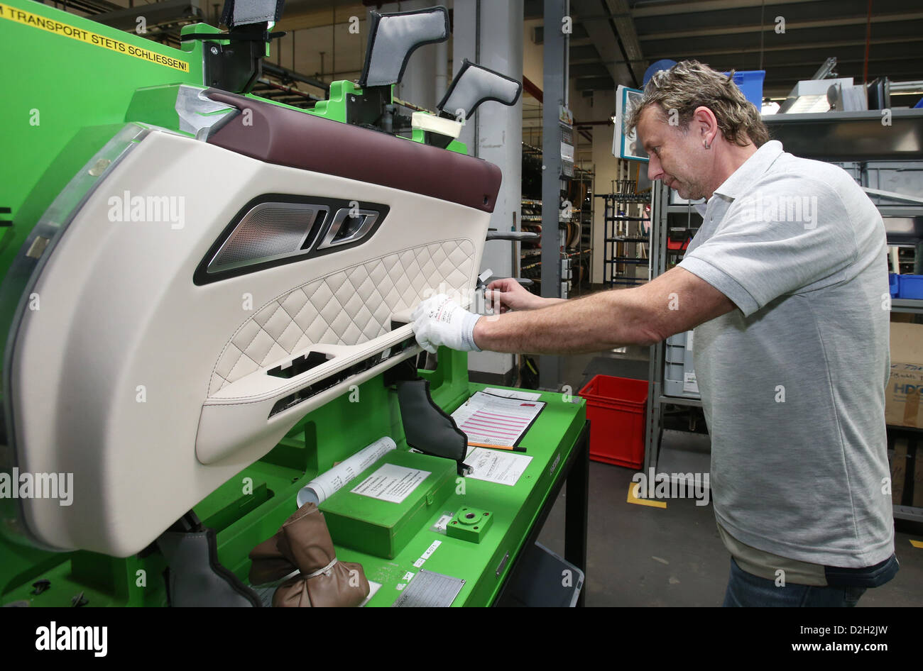 Employee Andreas Walther checks a door covering for a Mercedes Benz AMG ...