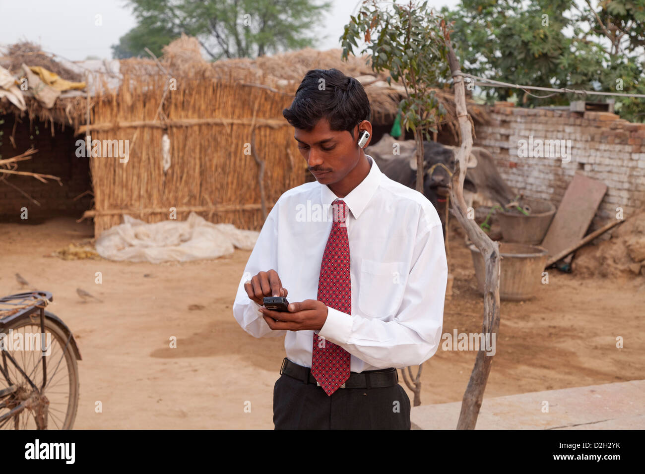 India,Uttar Pradesh, Agra, Young adult man wearing shirt and tie using ...