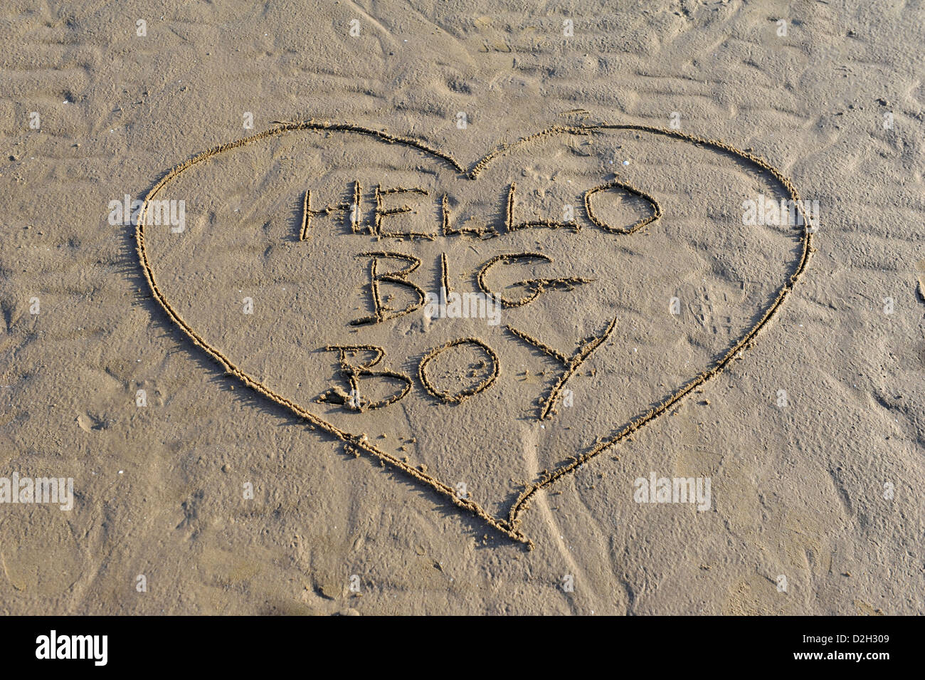 Word Hello Big Boy written in sand Stock Photo - Alamy