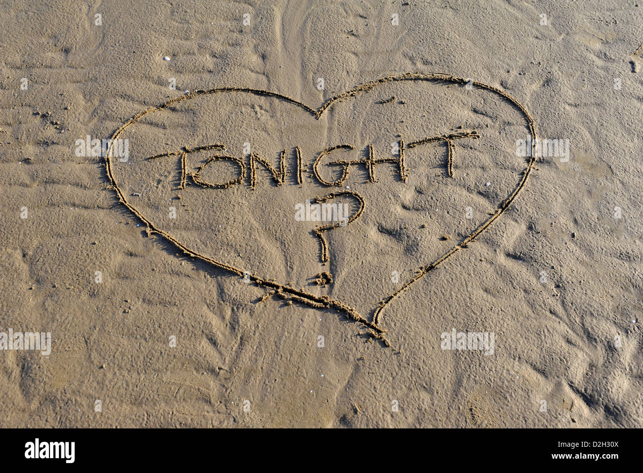 Word Tonight? written in sand Stock Photo - Alamy