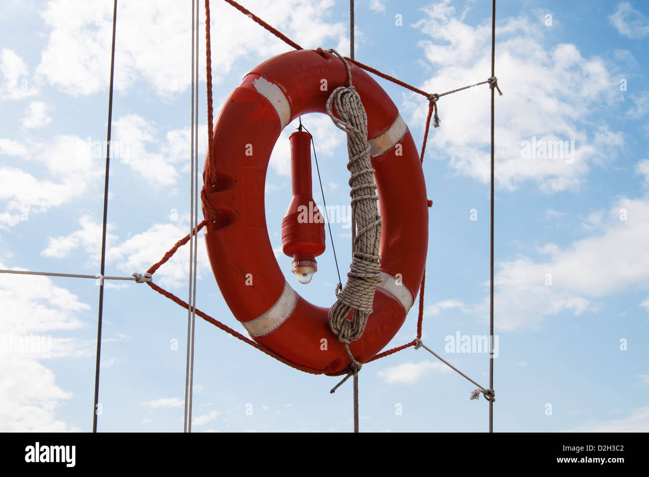 A rescue swim ring attached to the ropes of a traditional sailing ship ...