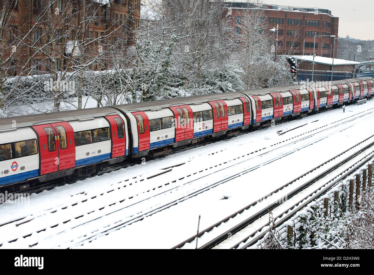 Snow covered Northern Line with tube train Stock Photo - Alamy