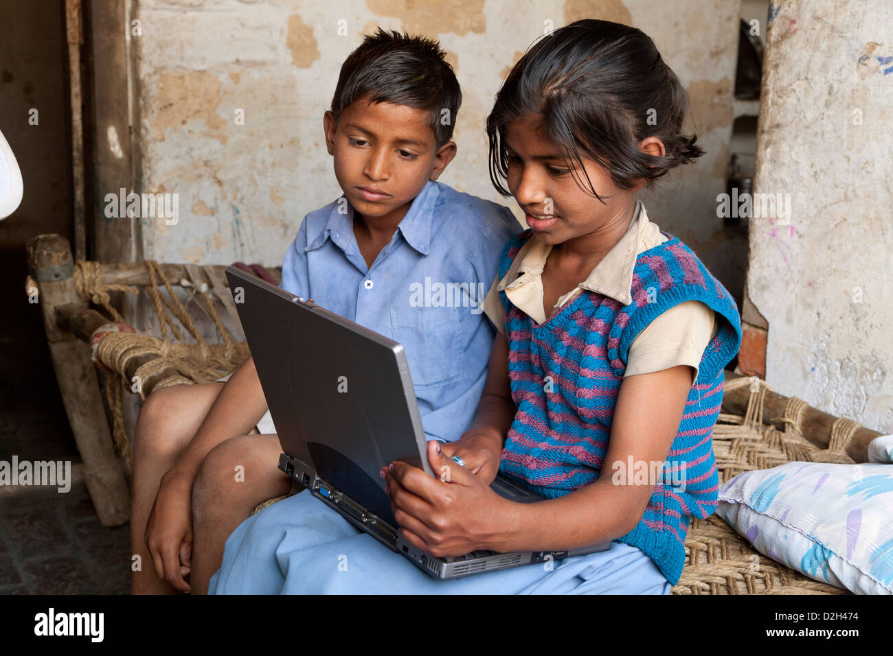 India, uttar Pradesh, Agra, pre-teenage girl using laptop being watched ...