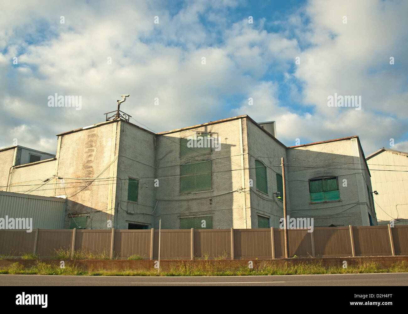 vacant factory behind a fence Stock Photo - Alamy