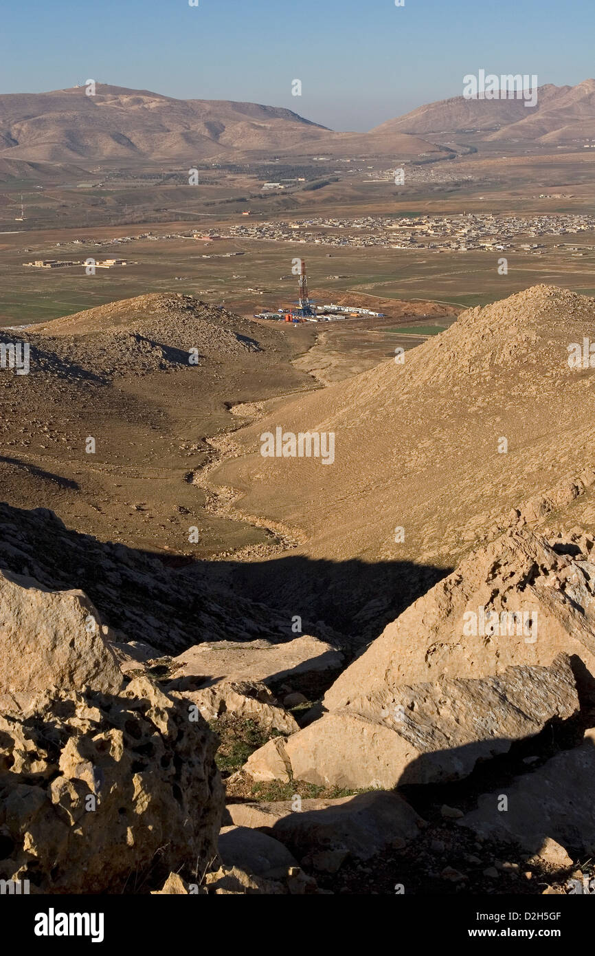Oil and gas exploration rig site in center of valley at end of gorge ...