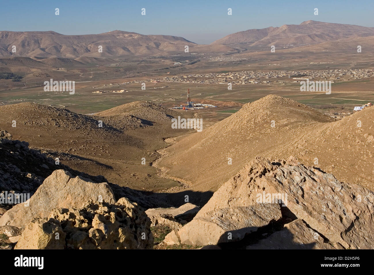 Oil and gas exploration rig site in center of valley at end of gorge ...