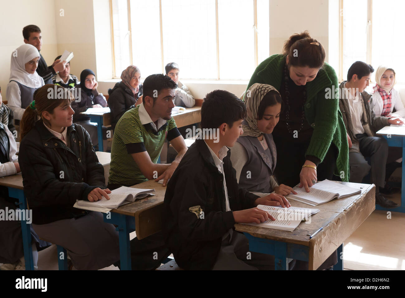 Inside secondary school classroom with male and female Muslim teenage ...