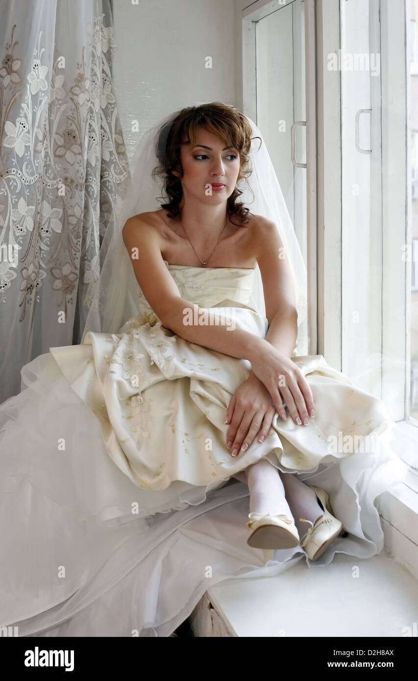 The beautiful thoughtful bride in an interior Stock Photo - Alamy