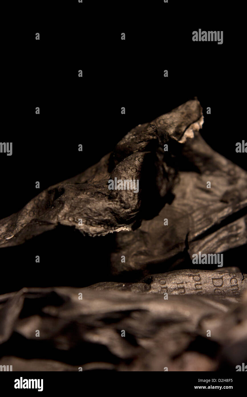 Ash of newspaper on black background Stock Photo - Alamy