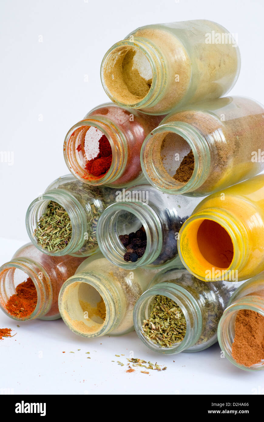 A studio shot of open spice jars balanced on top of each other in a ...