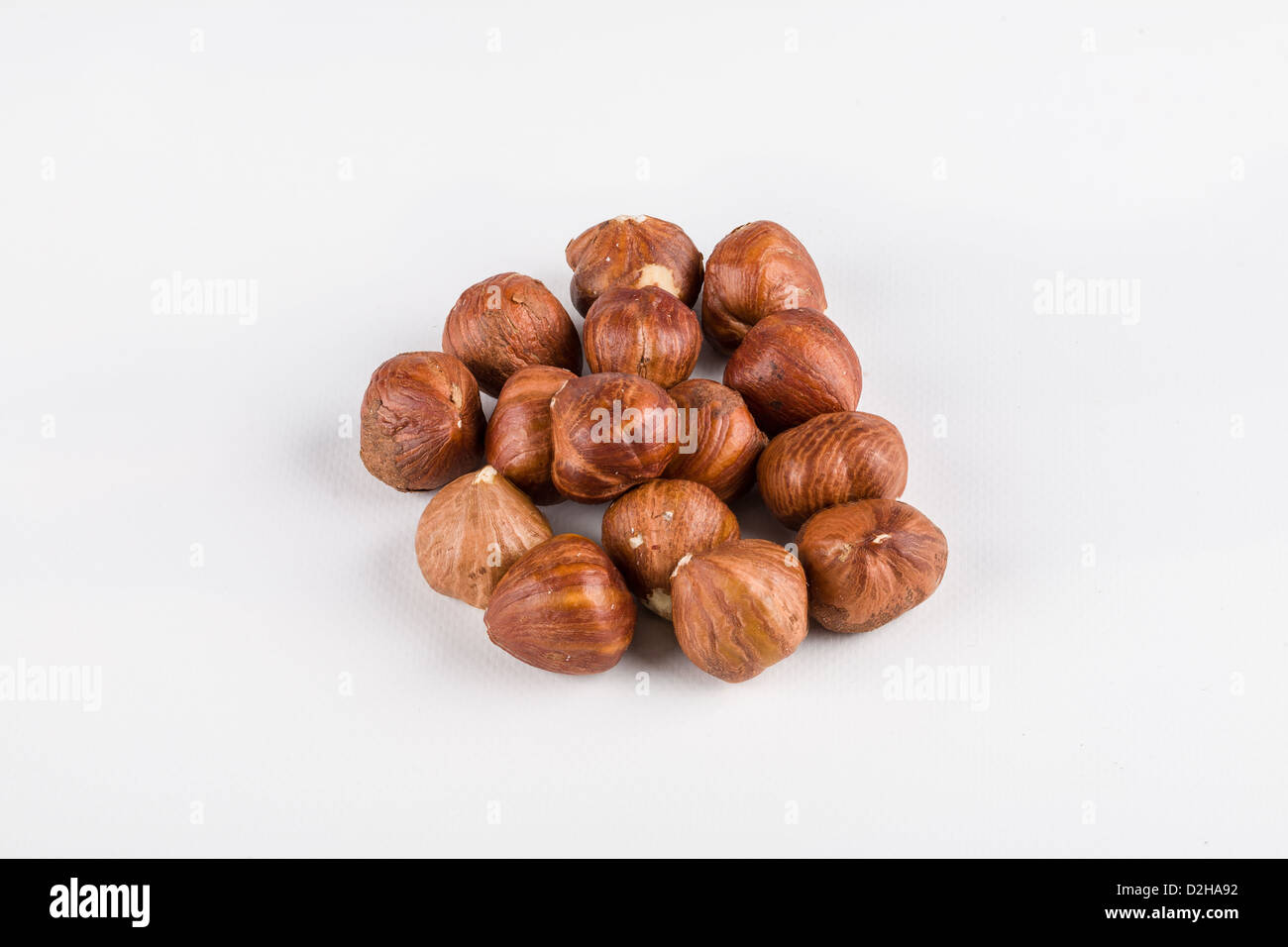 Small stack of hazelnuts with skin and no shell Stock Photo - Alamy