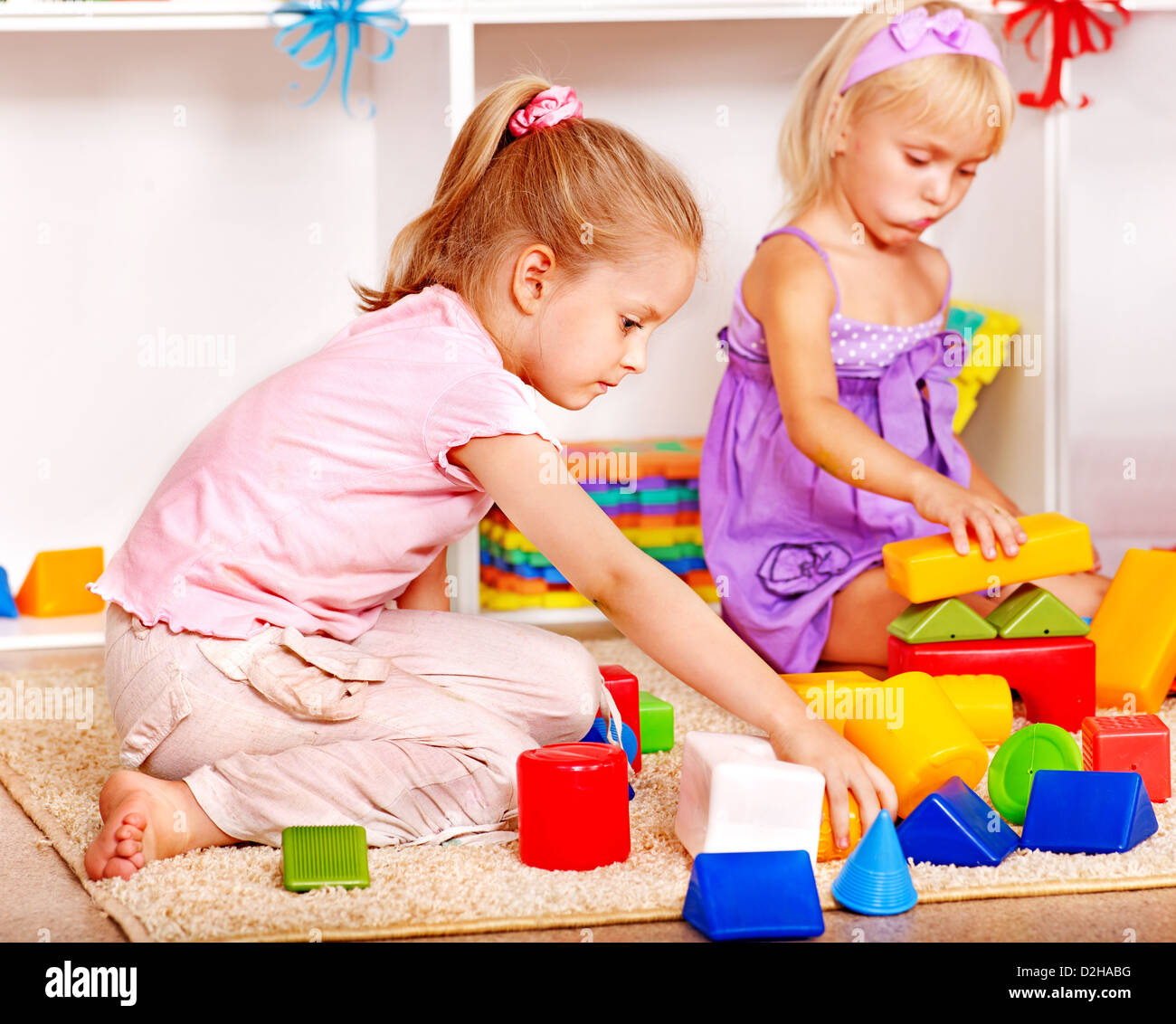 Children in kindergarten stacking block Stock Photo - Alamy