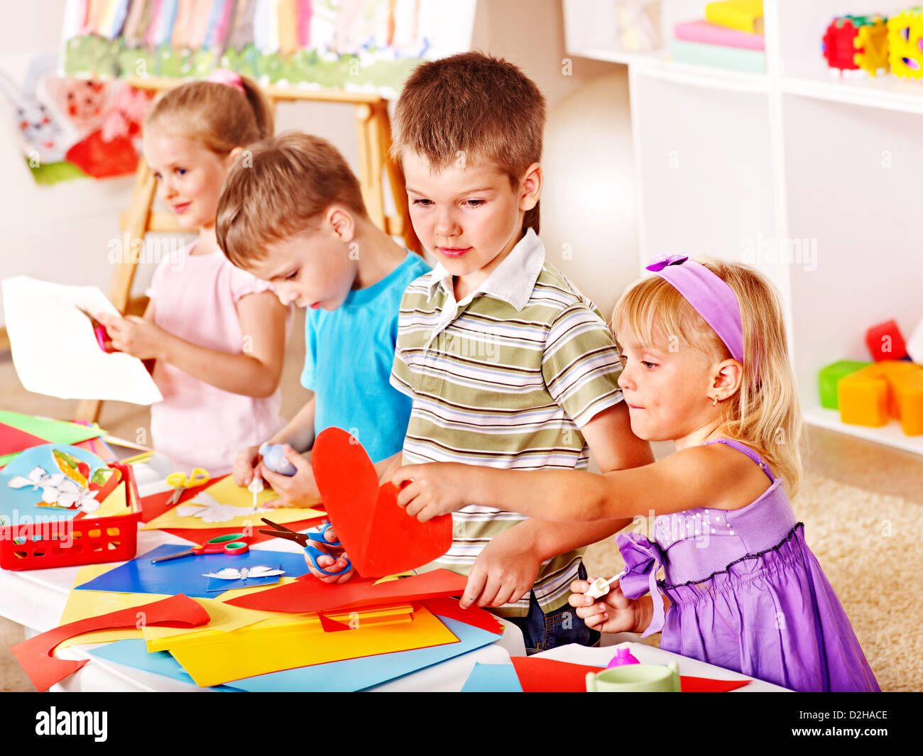 Children cutting out scissors paper in preschool Stock Photo - Alamy