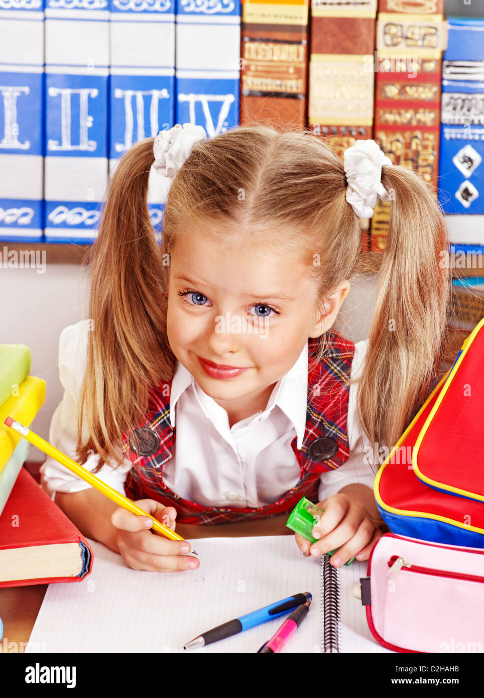 Child writing in classroom Stock Photo - Alamy