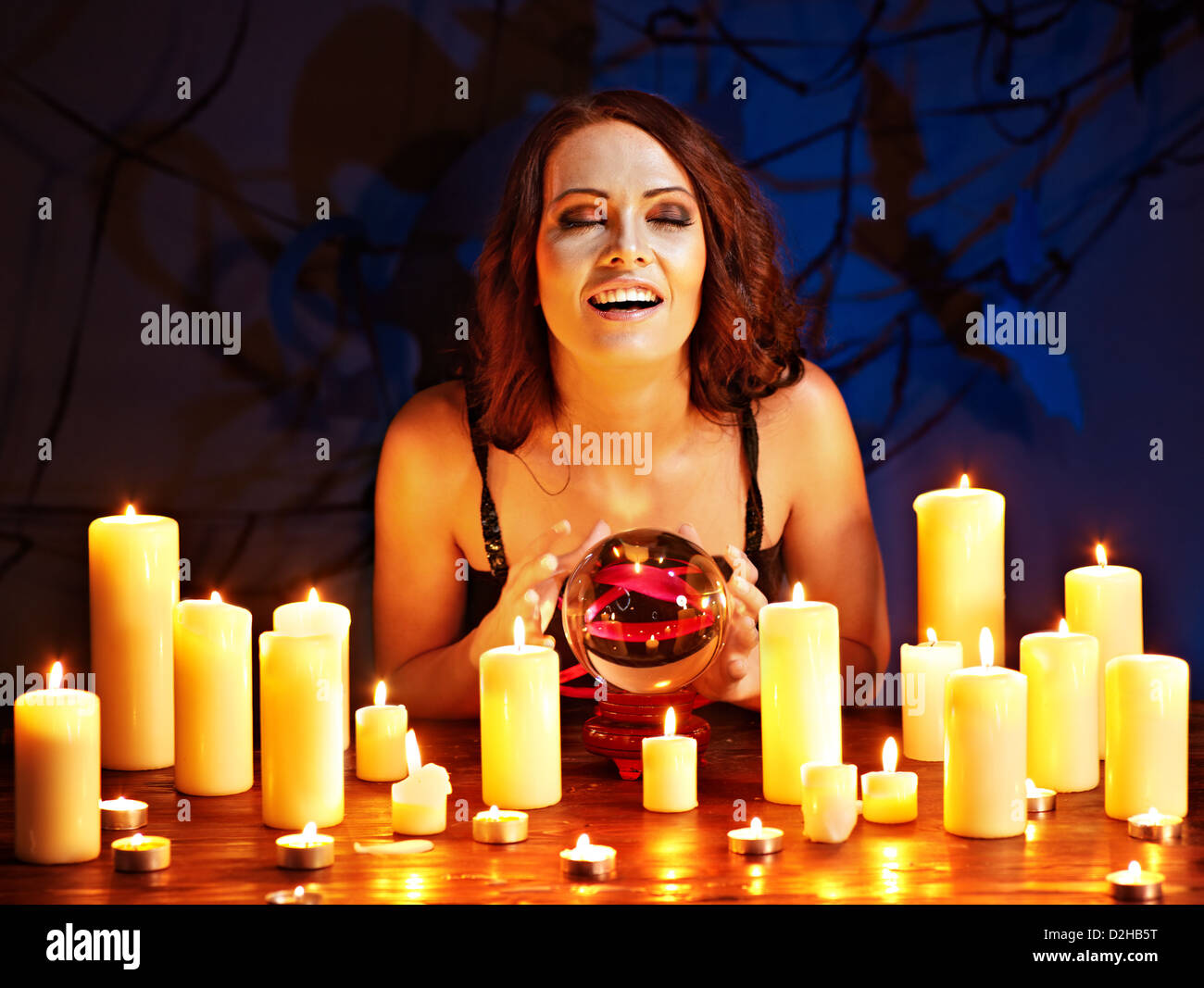 Woman holding scrying ball and candle Stock Photo - Alamy