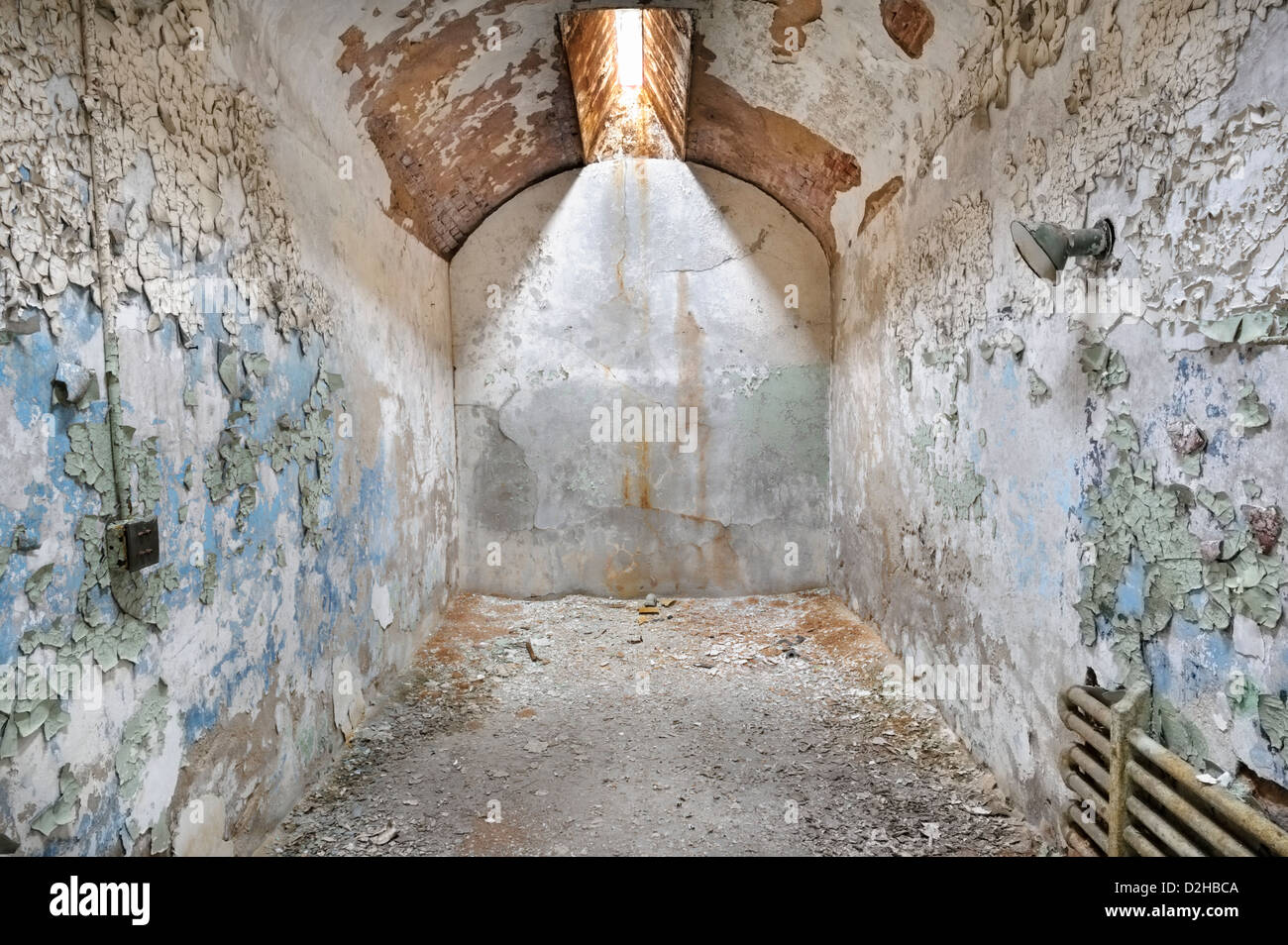 Prison cell with overhead skylight, abandoned and decaying ruins of ...