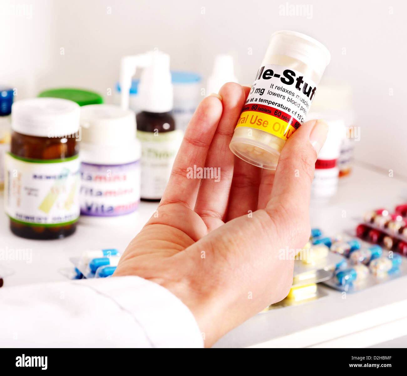Hand holding remedy Stock Photo - Alamy