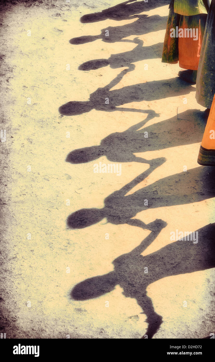 Shadow of Indian village children in a line holding hands playing games ...