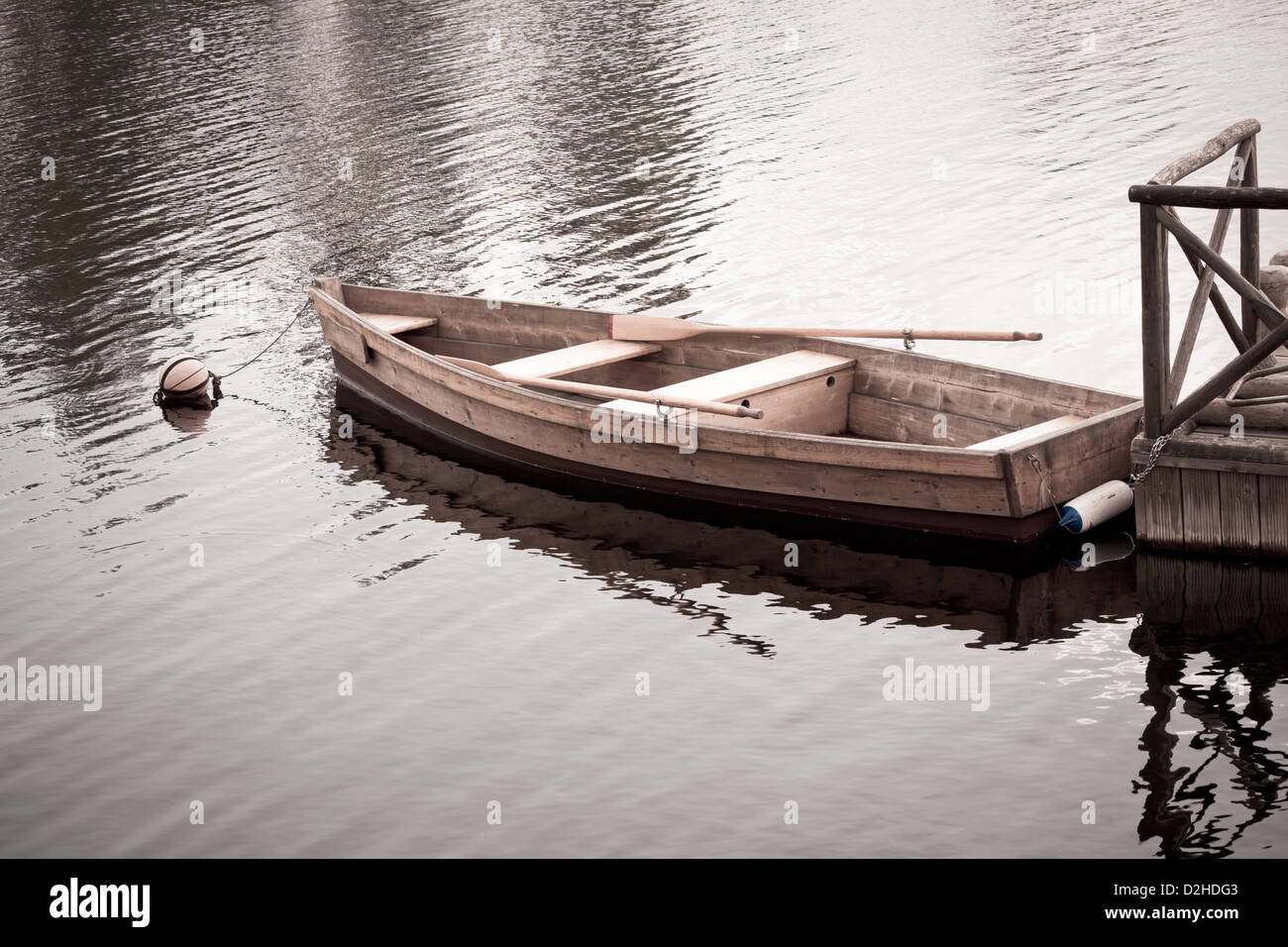 Floating wooden boat with paddles. Retro Toned shot Stock Photo - Alamy
