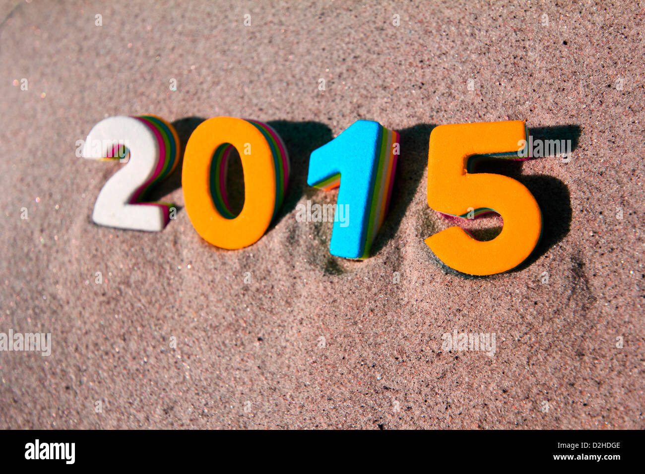 the year 2015 in colored numbers lying in sand Stock Photo - Alamy