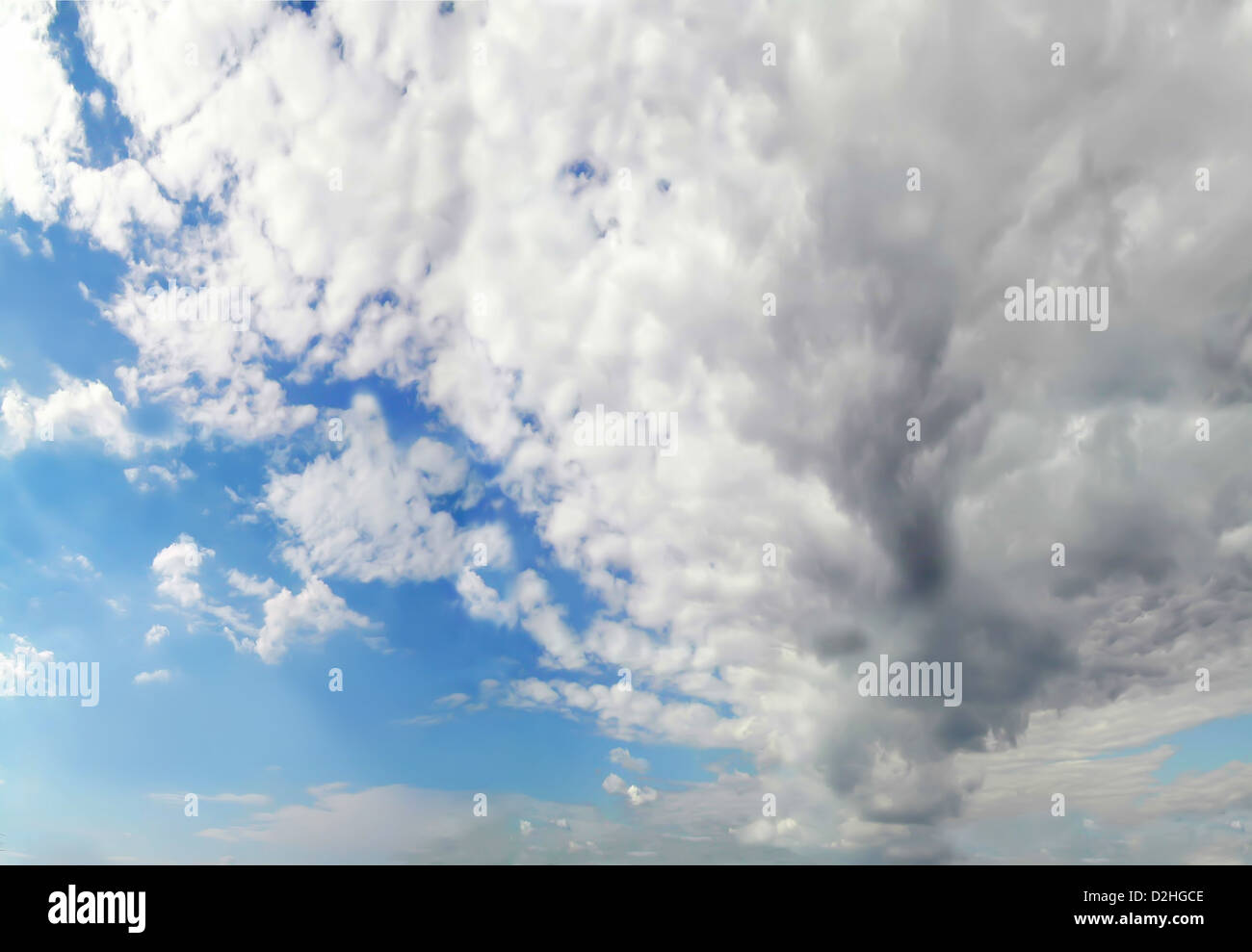 Blue sky with cumulus clouds in background and a large cloud front ...