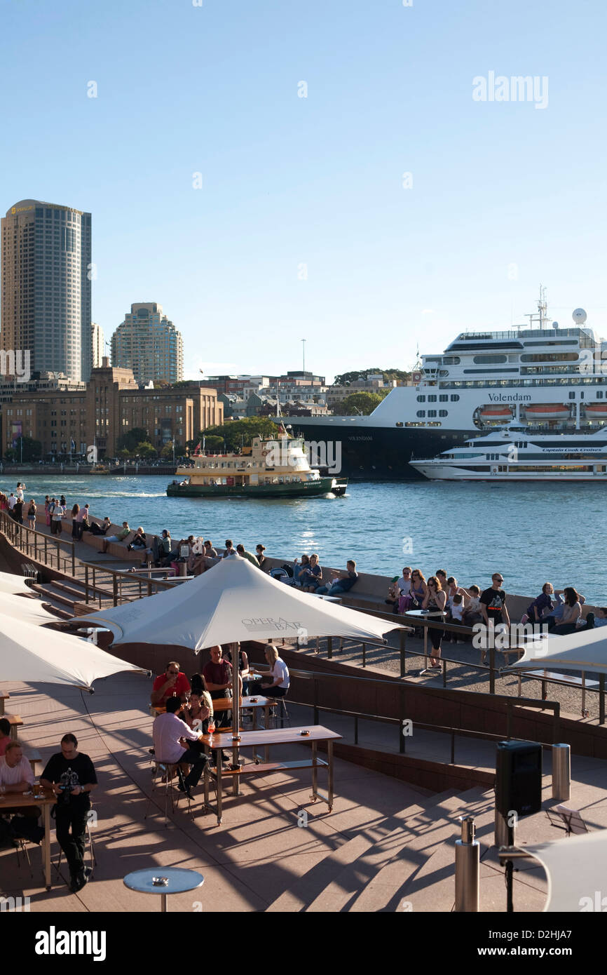 Bars and restaurants line the busy promenade of the Sydney Opera House ...