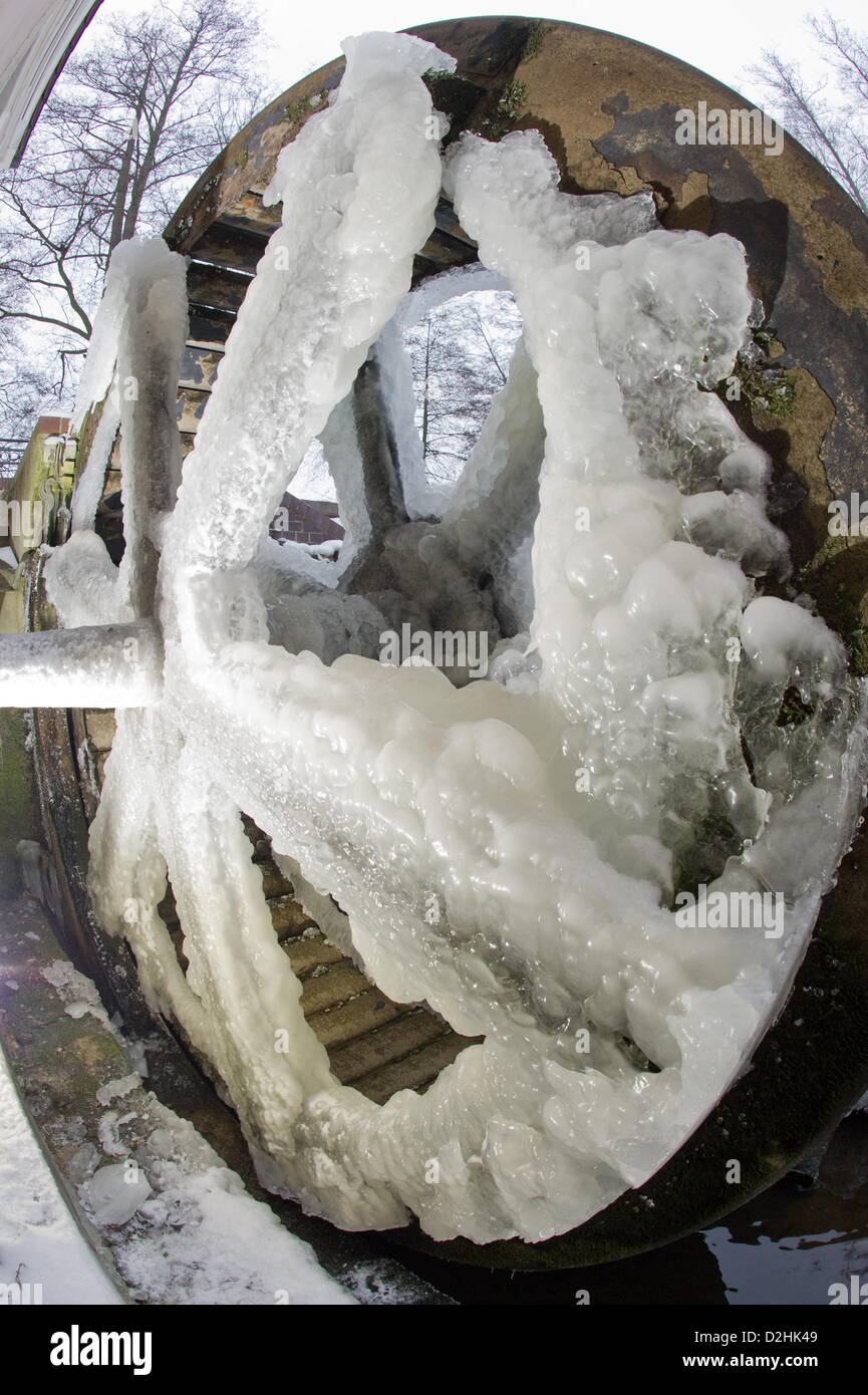 A mill wheel is coated with a thick layer of ice at minus 10 degrees ...