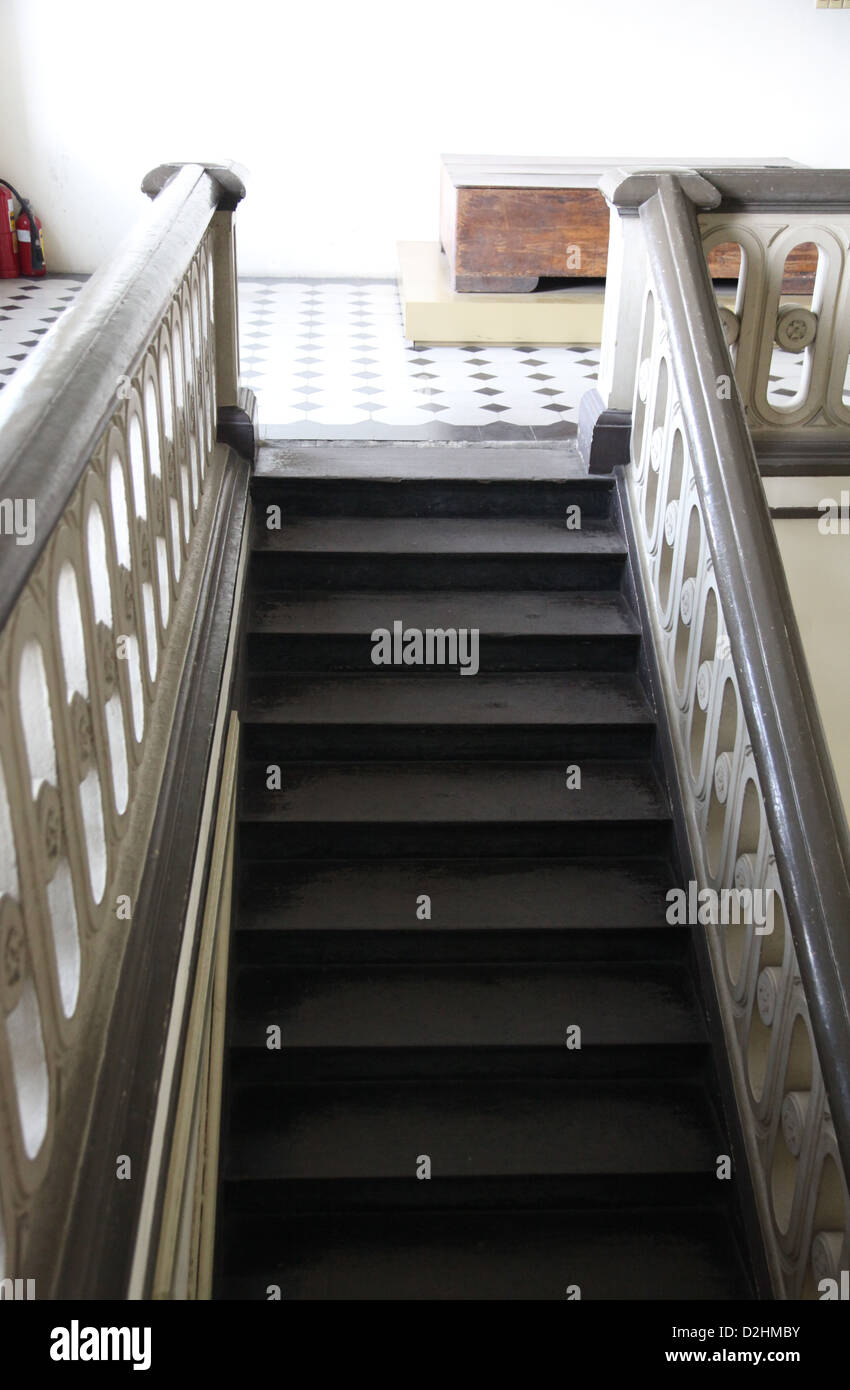 It's a photo of a old colonial style staircase in marble stone in a ...