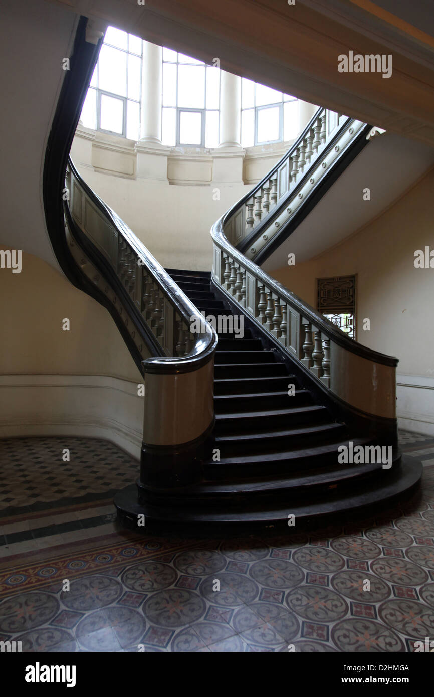 It's a photo of a old colonial style staircase in marble stone in a ...