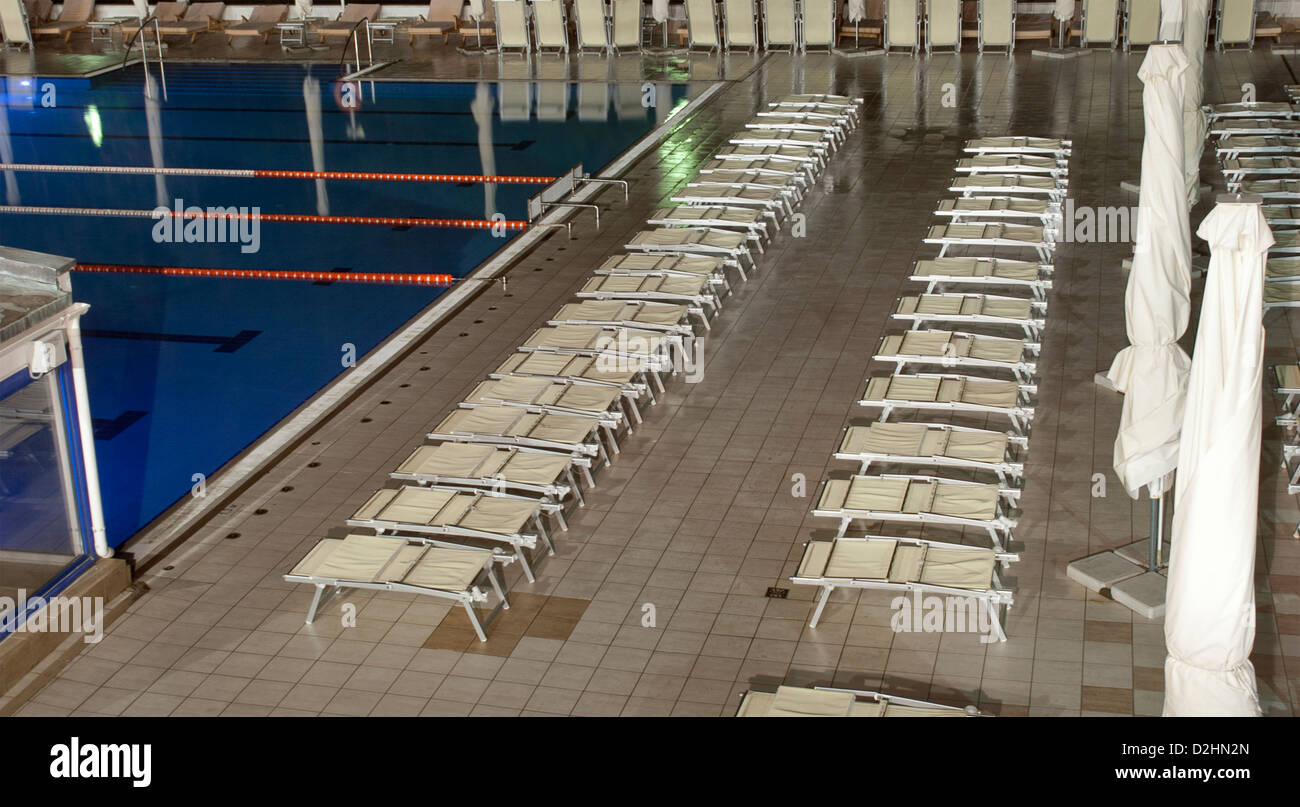 Open air swimming pool with folded chairs at night Stock Photo - Alamy