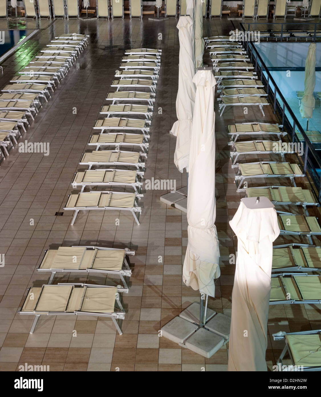 Open air swimming pool with folded deck chairs at night Stock Photo - Alamy