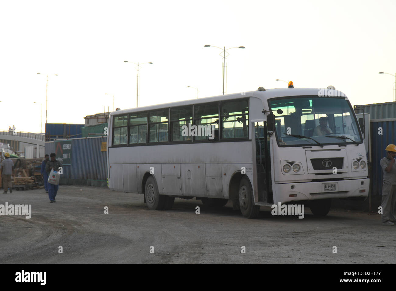 Bus picking up construction workers in Dubai, UAE Stock Photo - Alamy