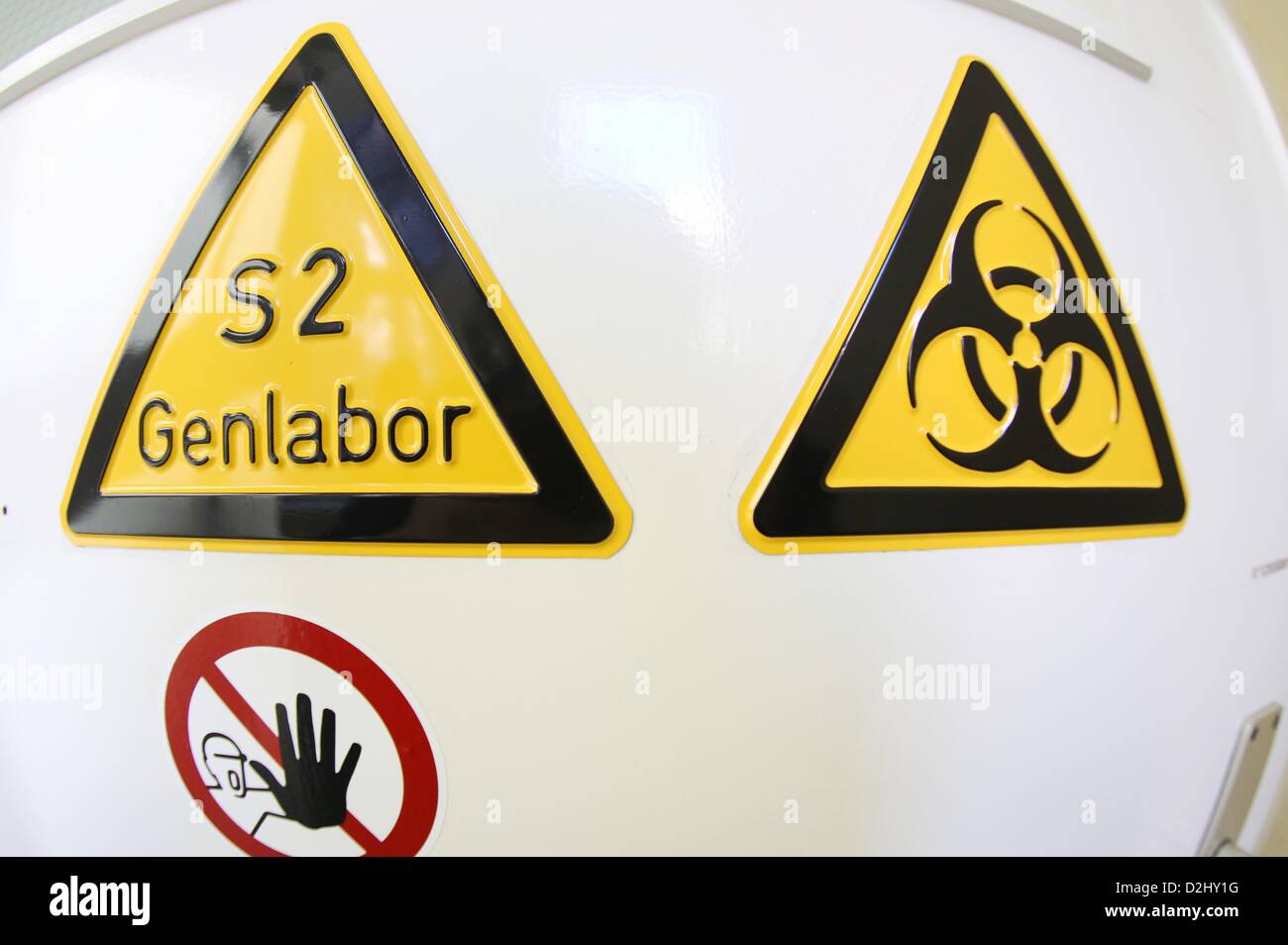 Warning signs and prohibition signs hang on a door to a gene laboratory ...