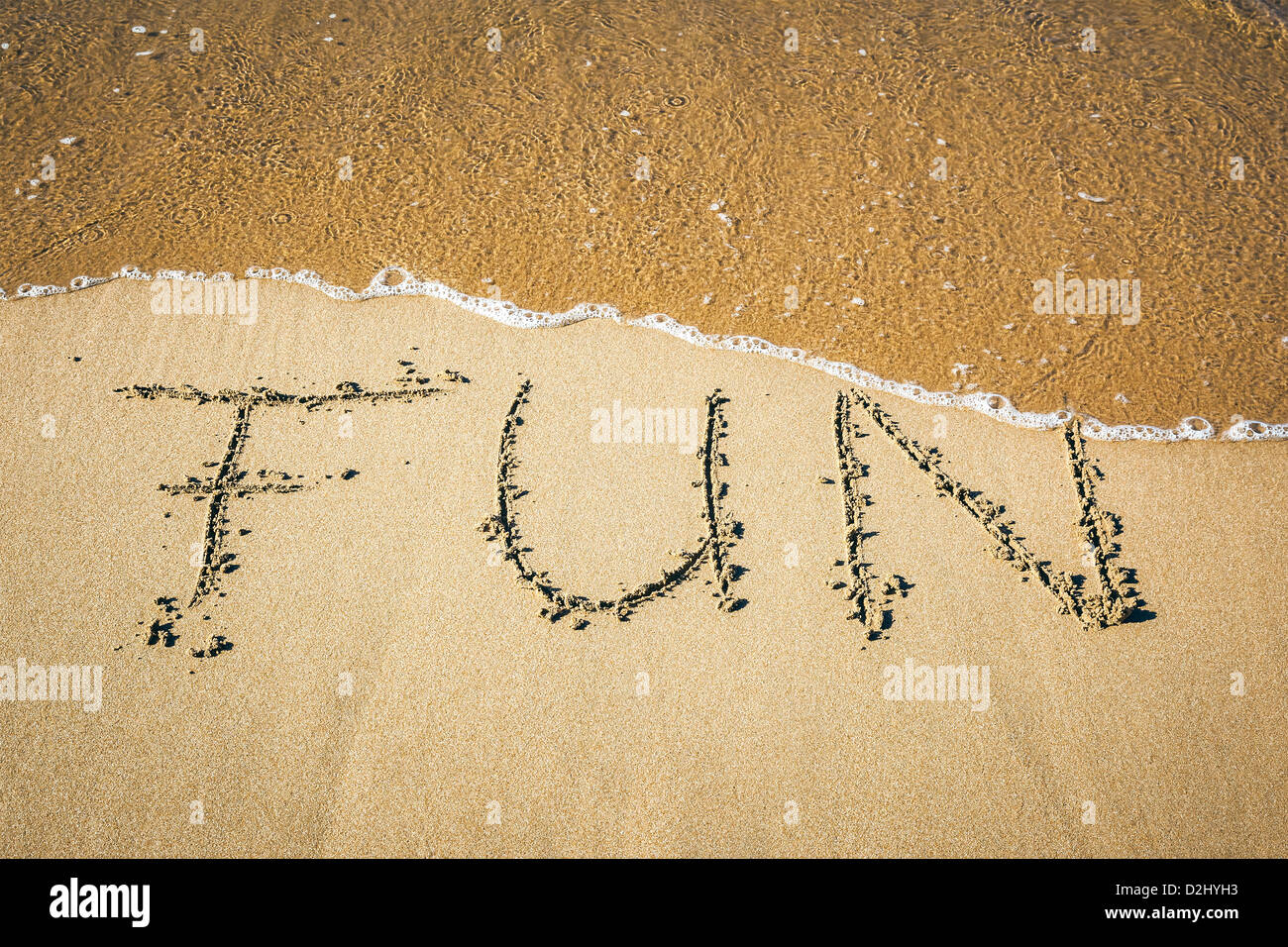 An image of a word in the sand: FUN Stock Photo - Alamy
