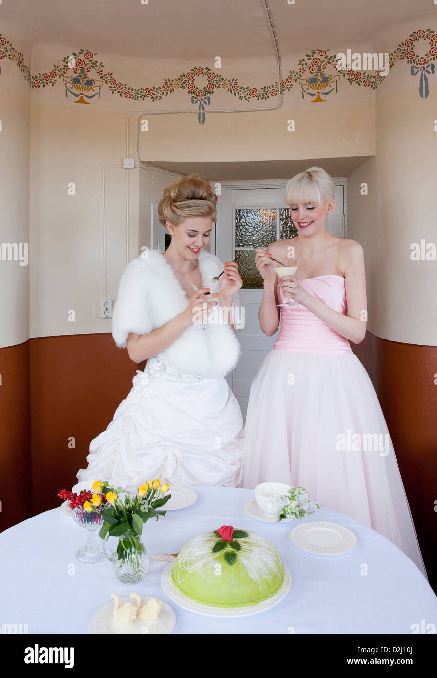 Two attractive young women wearing formal dresses are smiling. Vertical ...