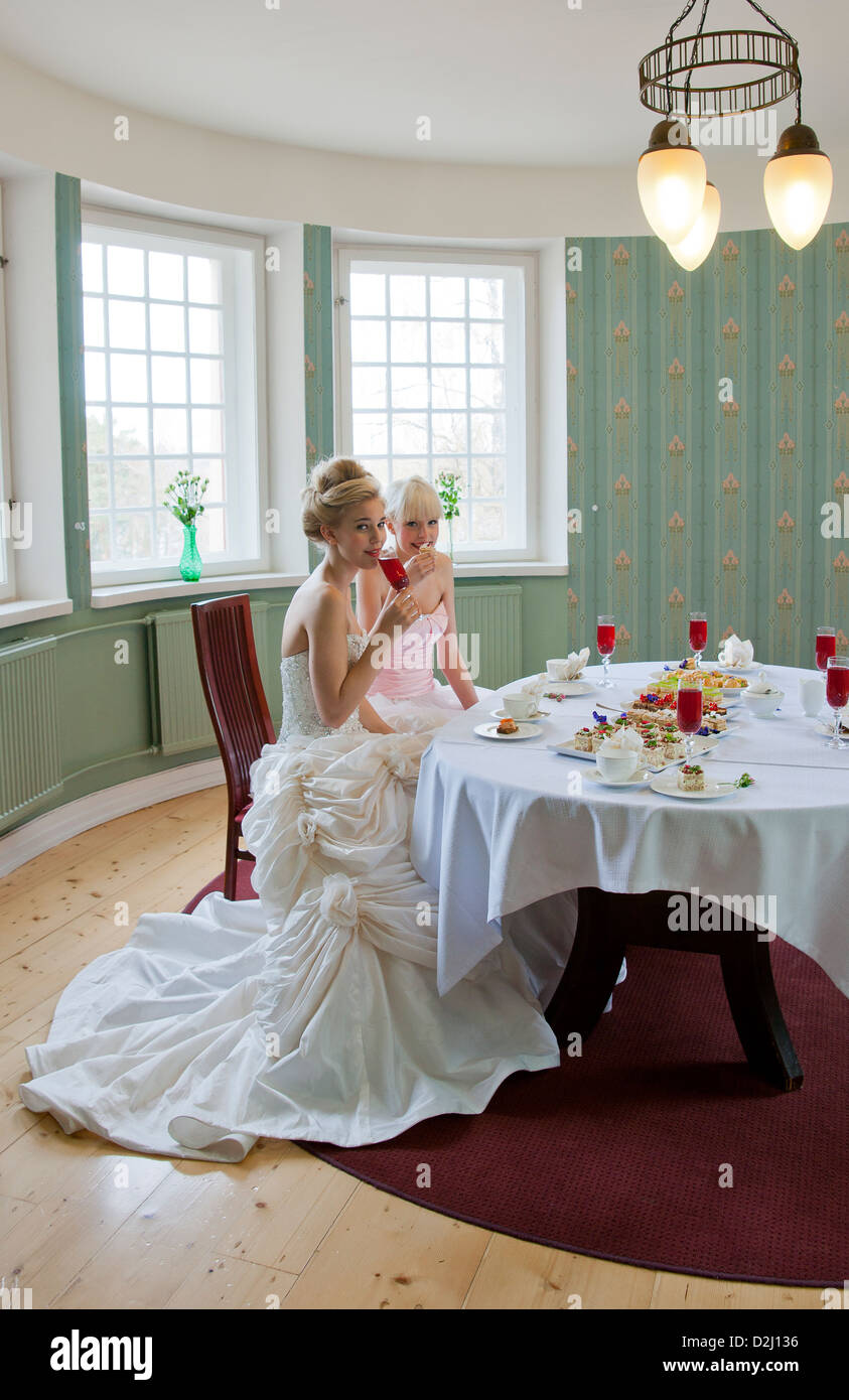 Two attractive young women wearing formal dresses are smiling. Vertical ...