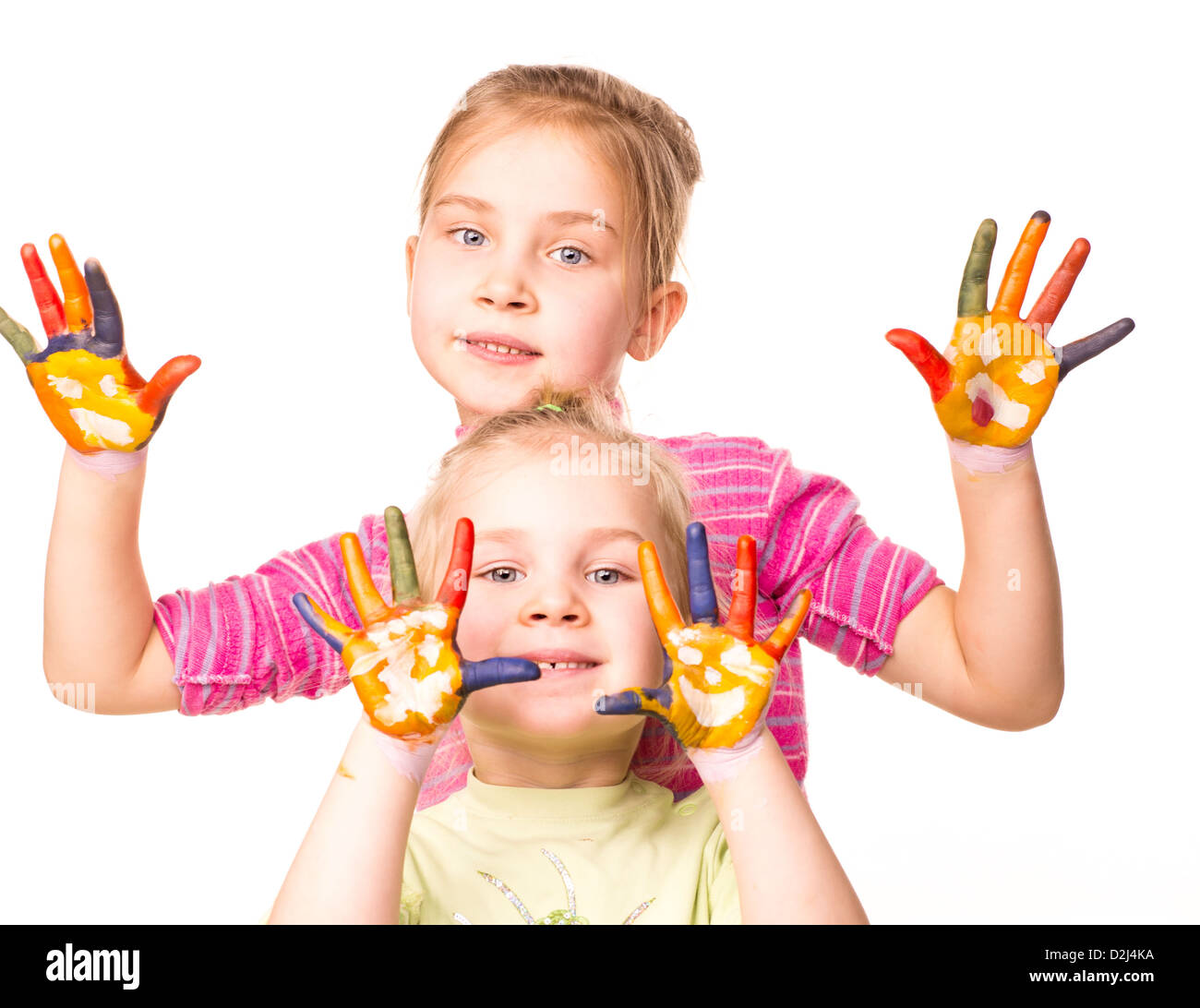Two happy girls showing hands painted in bright colors, isolated over ...